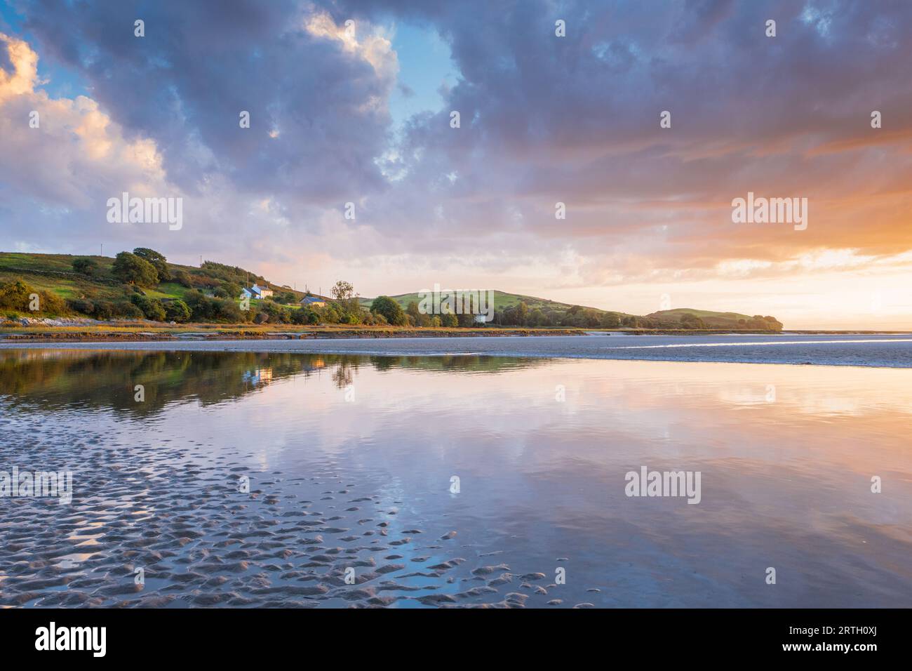 Sunset at Traeth Bach with blue sky and calm sea Stock Photo - Alamy
