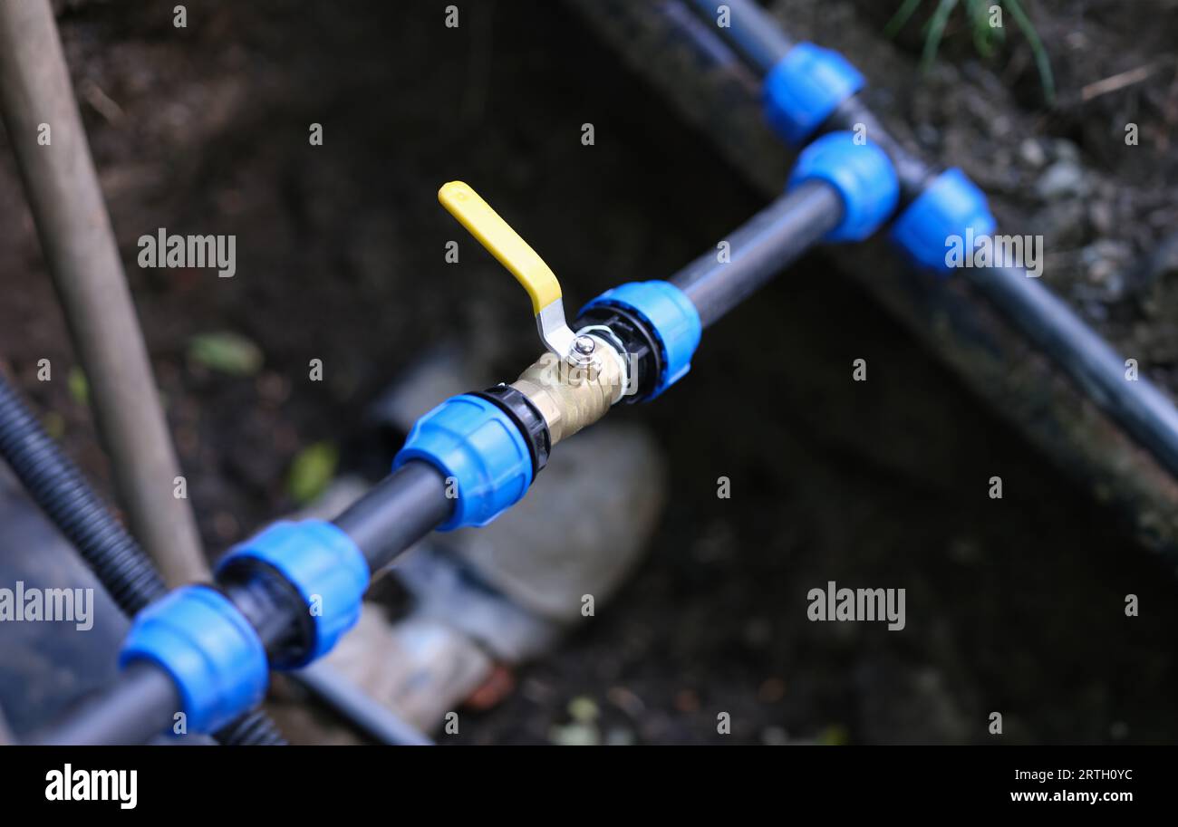 Water valve connected to PVC pipe closeup Stock Photo - Alamy