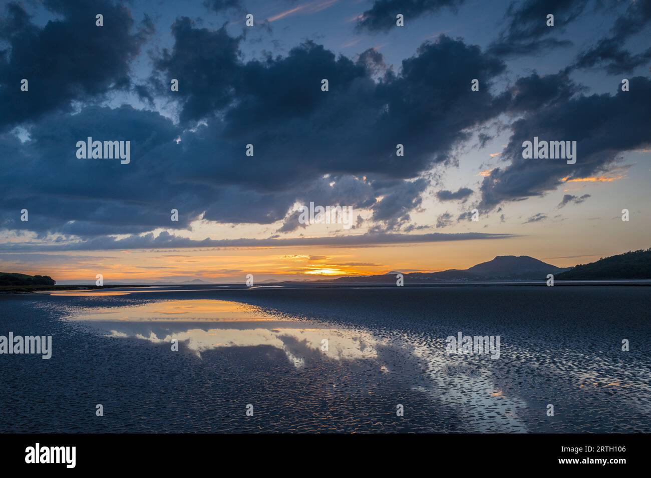 Sunset at Traeth Bach with blue sky and calm sea Stock Photo - Alamy