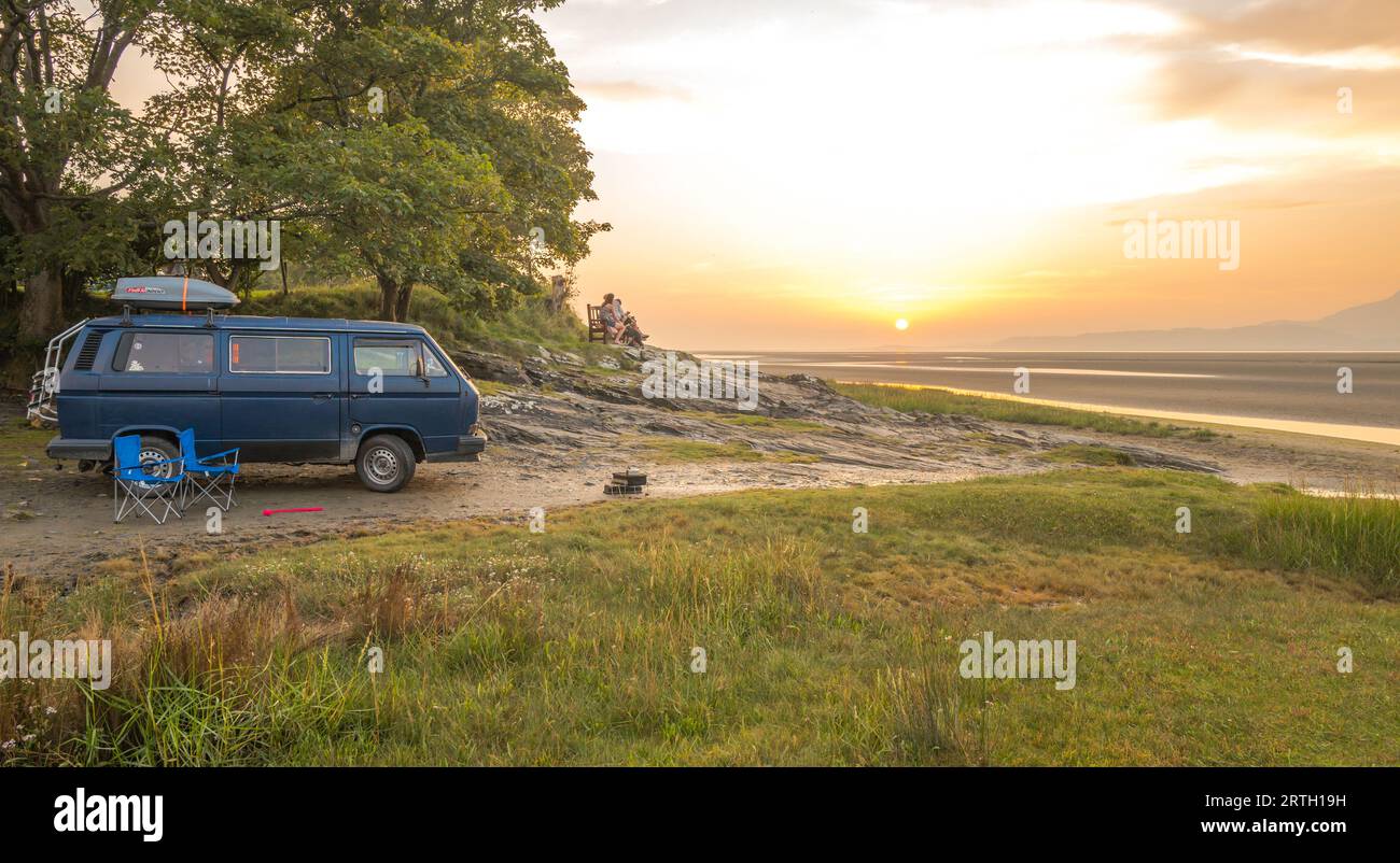 Sunset at Traeth Bach with blue sky and calm sea with VW campervan ...