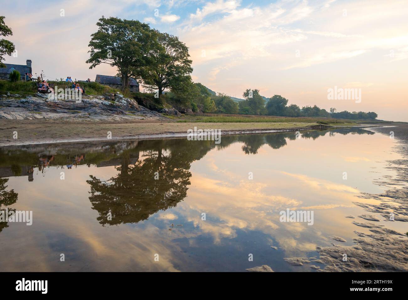 Sunset at Traeth Bach with blue sky and calm sea Stock Photo - Alamy