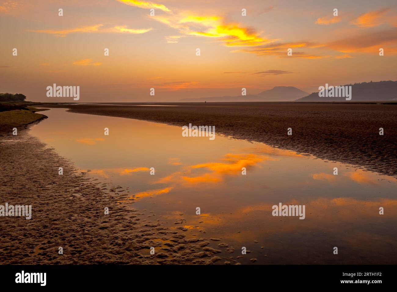 Sunset at Traeth Bach with blue sky and calm sea Stock Photo - Alamy