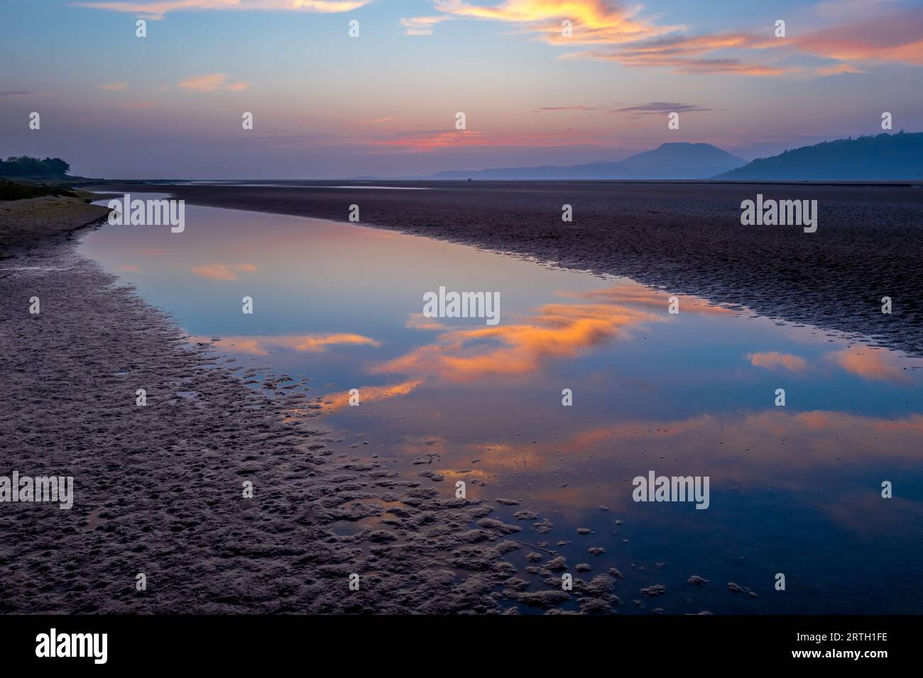 Sunset at Traeth Bach with blue sky and calm sea Stock Photo - Alamy