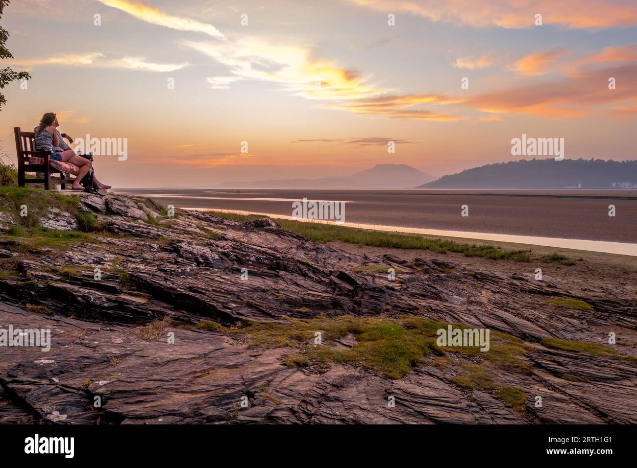 Sunset at Traeth Bach with blue sky and calm sea Stock Photo - Alamy