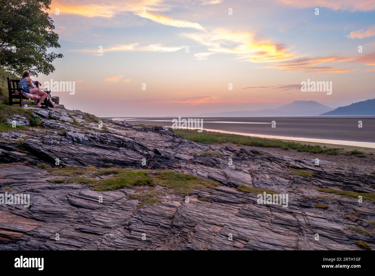 Sunset at Traeth Bach with blue sky and calm sea Stock Photo - Alamy