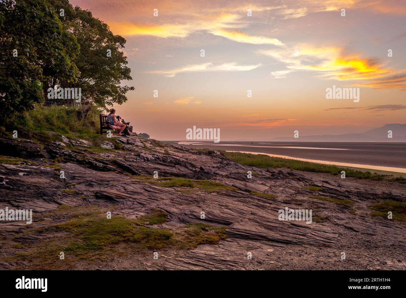 Sunset at Traeth Bach with blue sky and calm sea Stock Photo - Alamy