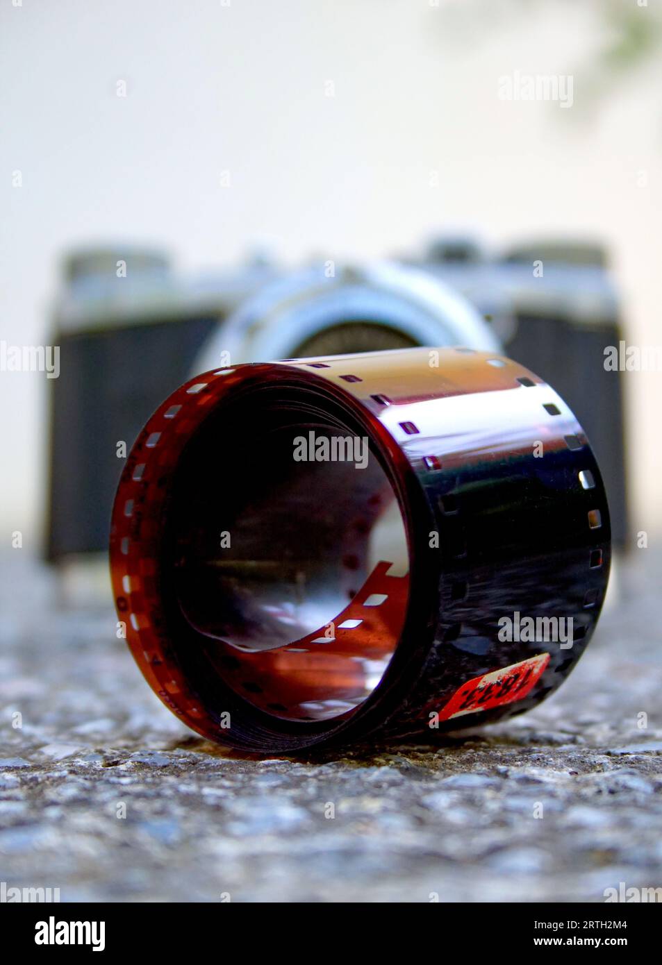 Roll of developped 35 mm coloured film in front of vintage camera Stock ...