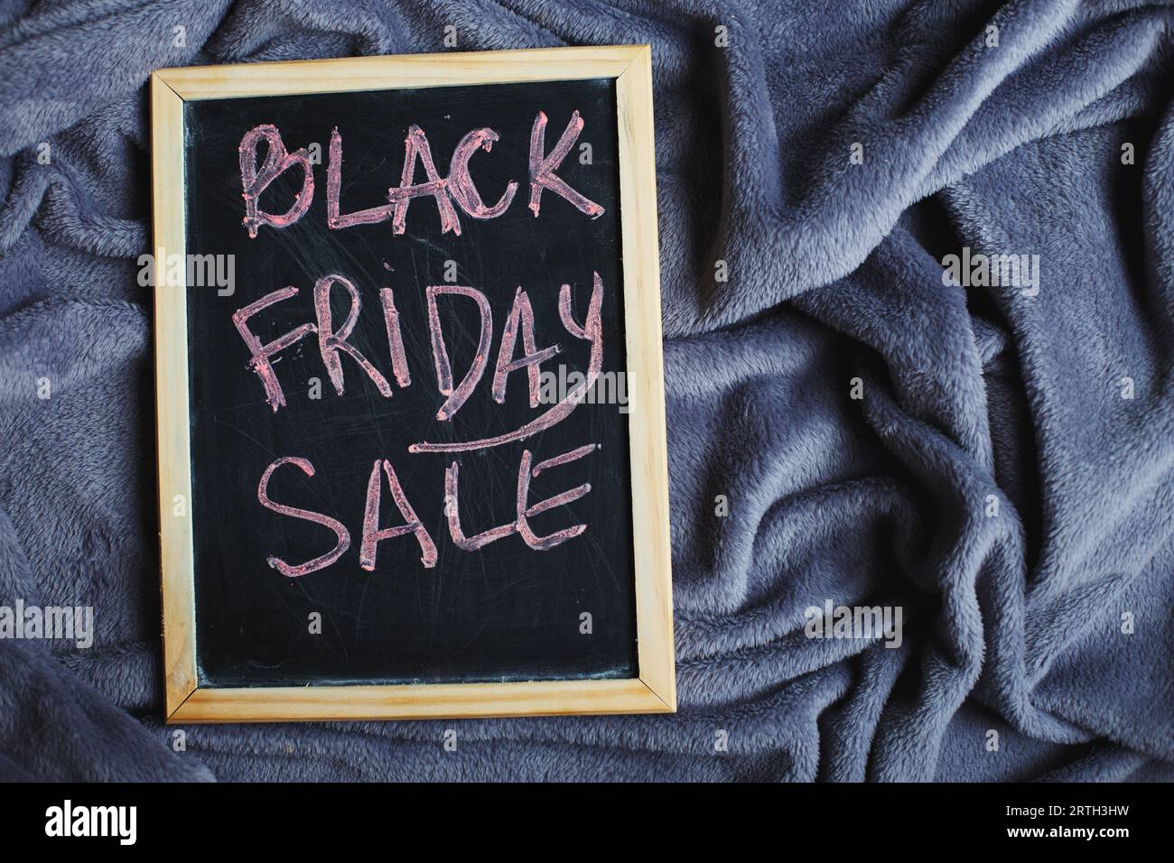 friday sale announcement on a blackboard on grey textile plush fabric ...