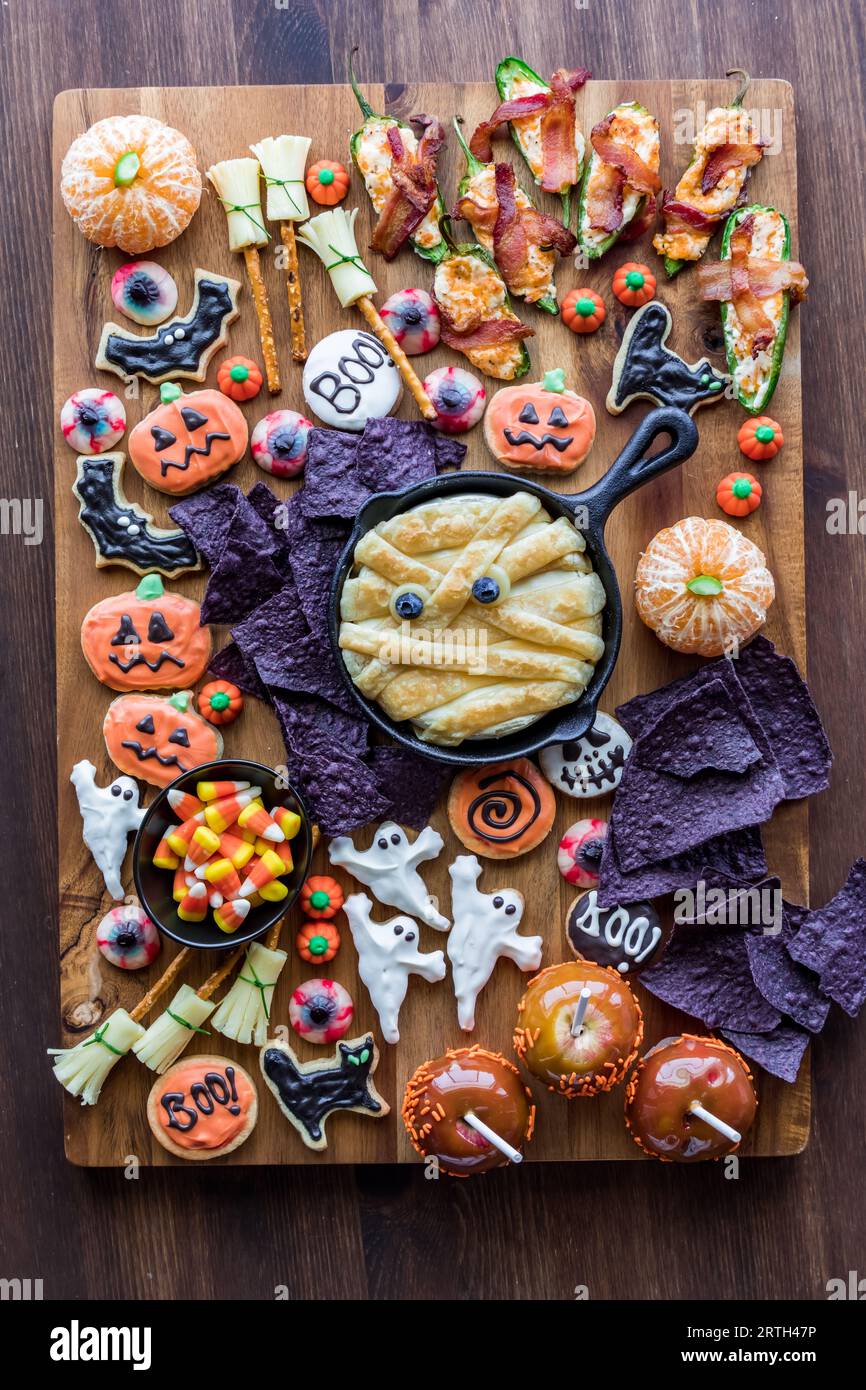 A Halloween Themed Charcuterie Board Topped With Sweet And Savoury