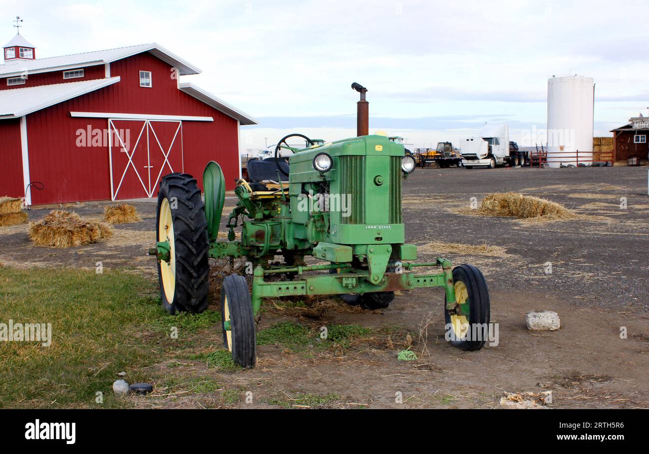 A tractor parked outside of a barn in the countryside Stock Photo - Alamy