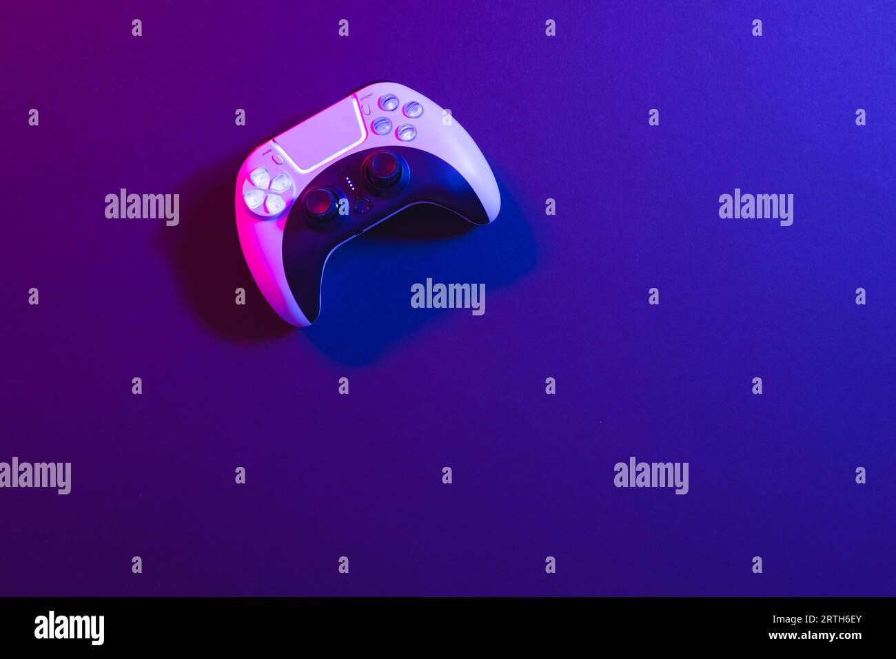 Composite of video game pad and copy space on neon background Stock ...