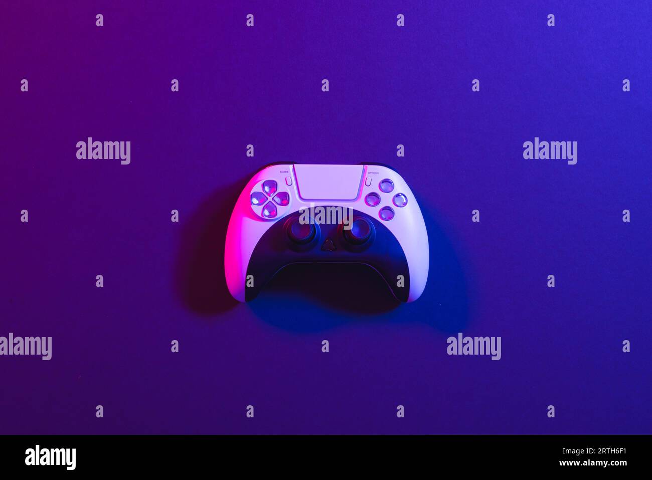 Composite of video game pad and copy space on neon background Stock ...