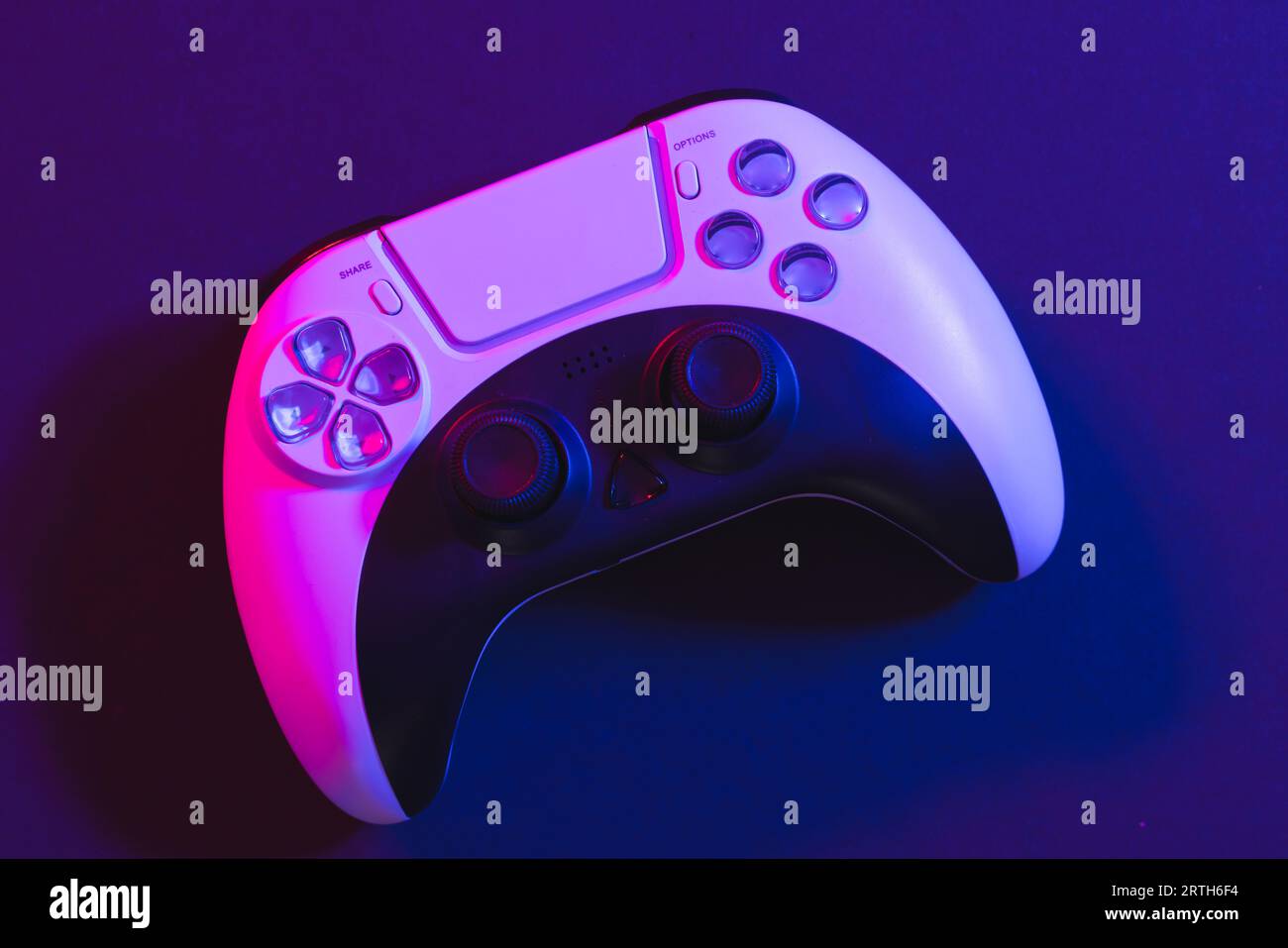 Composite of video game pad and copy space on neon background Stock ...