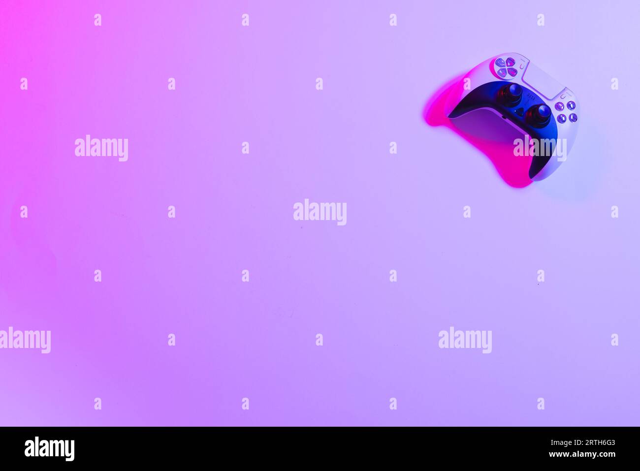 Composite of video game pad and copy space on neon background Stock ...
