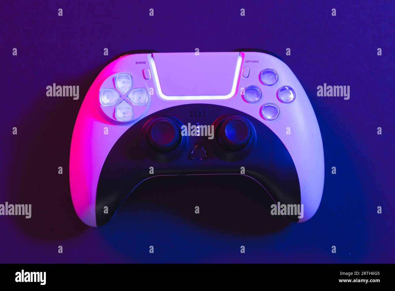 Composite of video game pad and copy space on neon background Stock ...