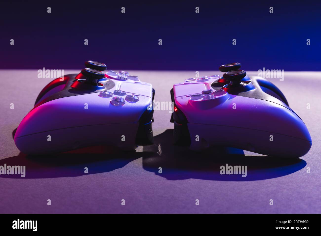 Composite of video game pads and copy space on neon background Stock ...