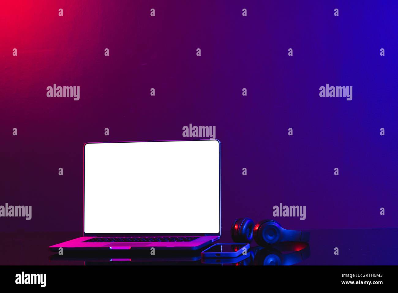 Composite of laptop with blank screen and video game accessories, copy ...