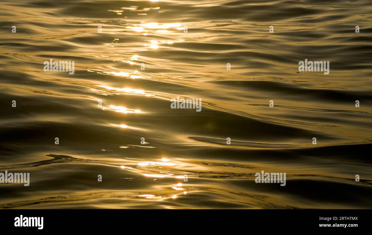 abstract waves forming on the sea at sunset ,yellow black sunset ...