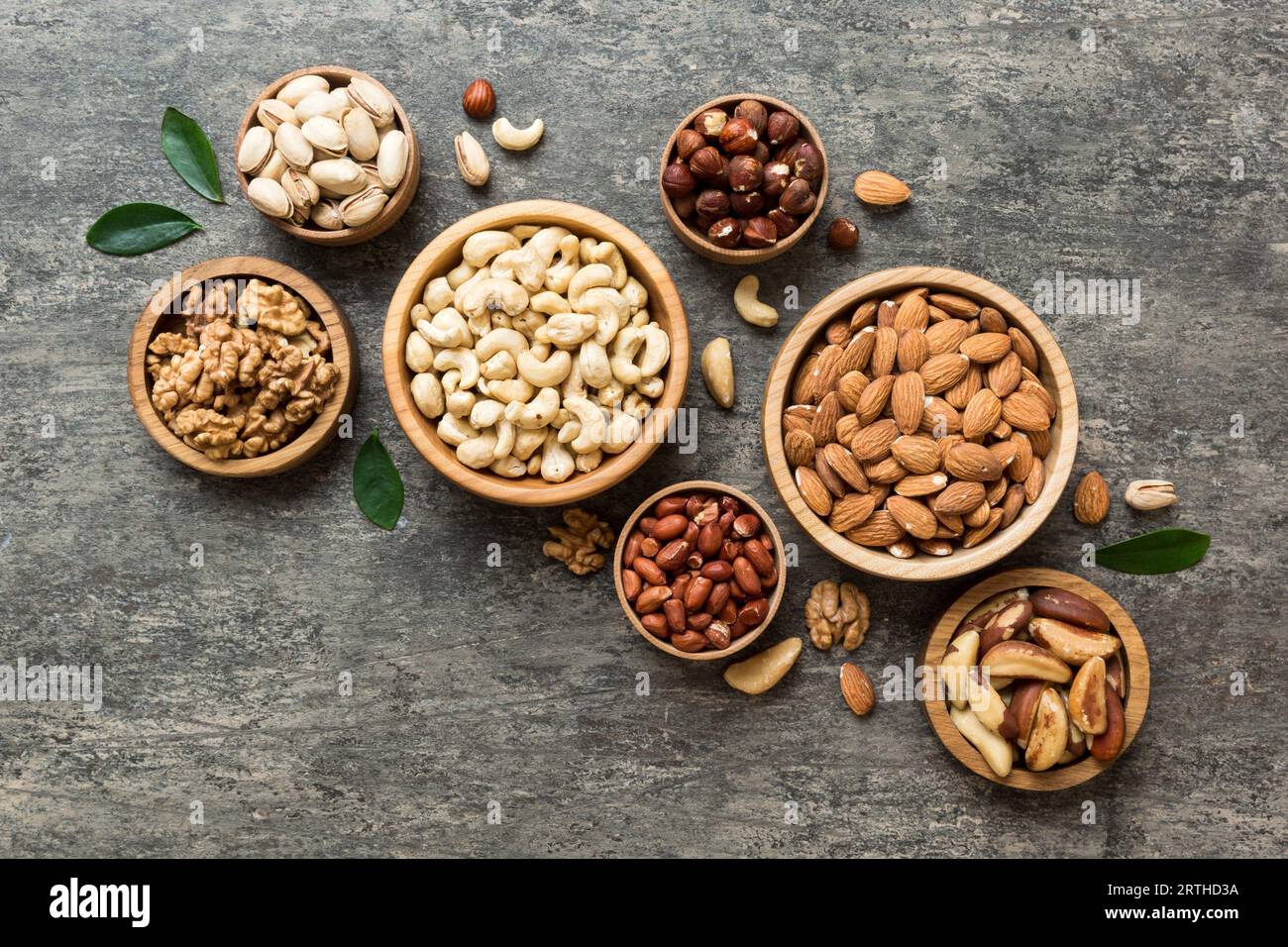 mixed nuts in wooden bowl. Mix of various nuts on colored background ...