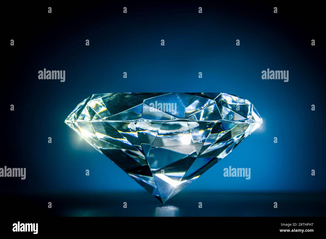 large classic-cut diamond on a blue background Stock Photo - Alamy