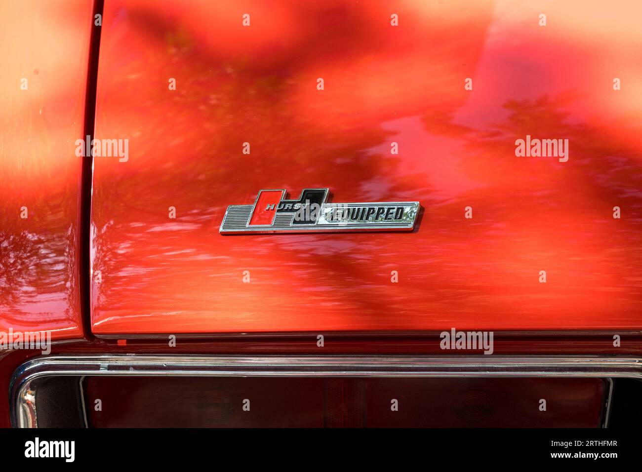A closeup of the iconic Hurst Equipped emblem on a bright red, glossy ...