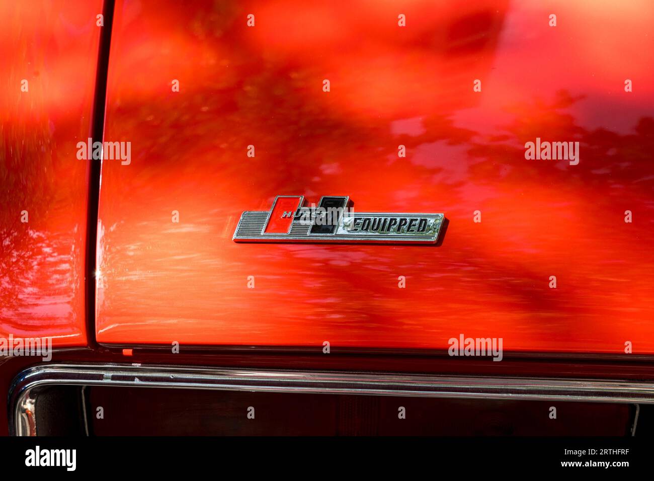 A closeup of the iconic Hurst Equipped emblem on a bright red, glossy ...
