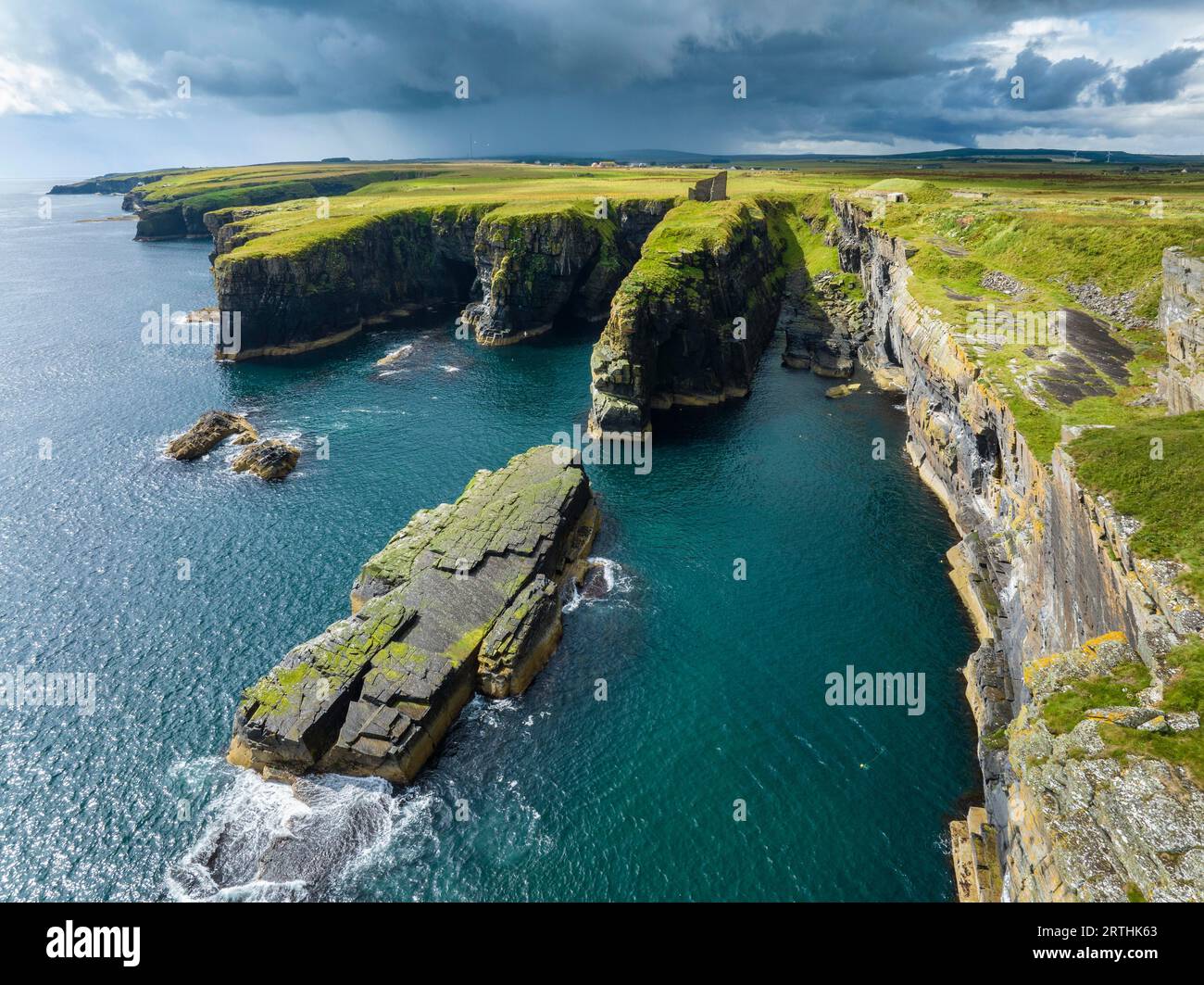 Aerial view of the ruined Castle of Old Wick surrounded by rugged ...