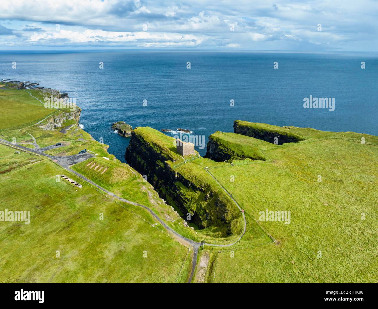Aerial view of the ruined Castle of Old Wick surrounded by rugged ...