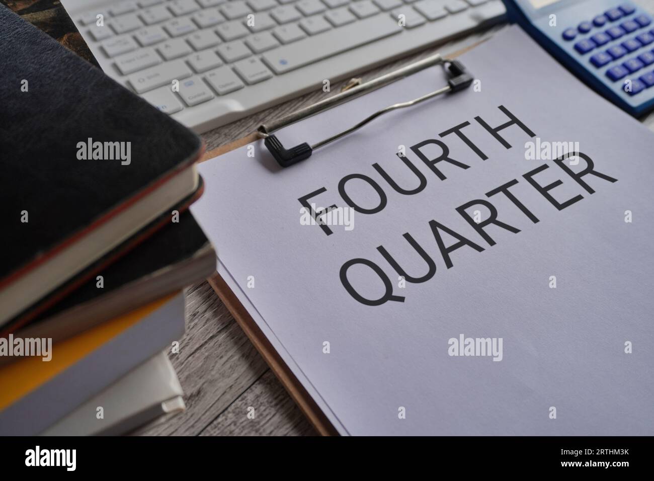 Close up image of paper clipboard with text FOURTH QUARTER on office ...