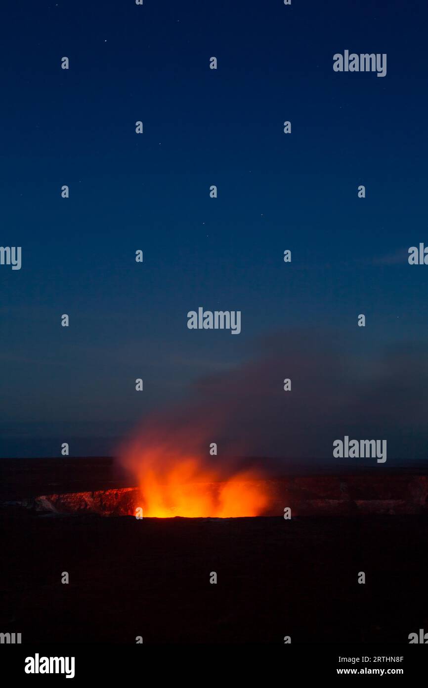 A lava lake in Halemaumau Crater on Kilauea illuminates rising volcanic ...