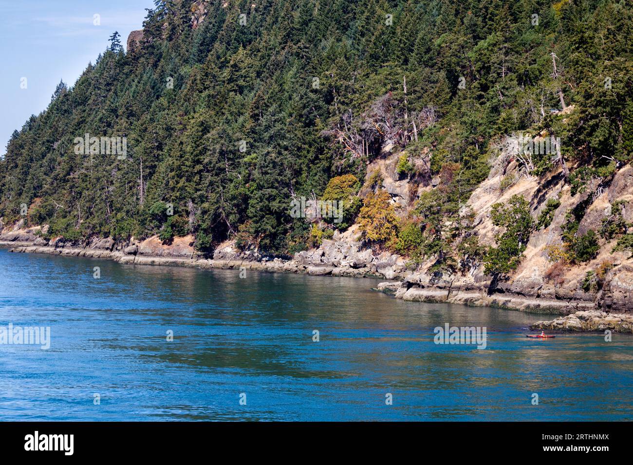 Kayakers on the cliffs of an island in the Strait of Georgia off ...