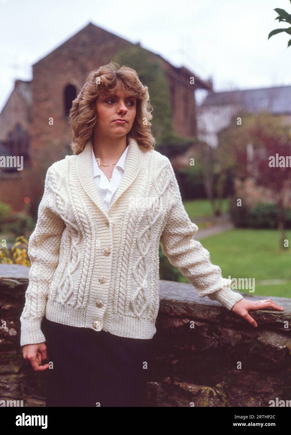 Model wearing a white cardigan Stock Photo - Alamy