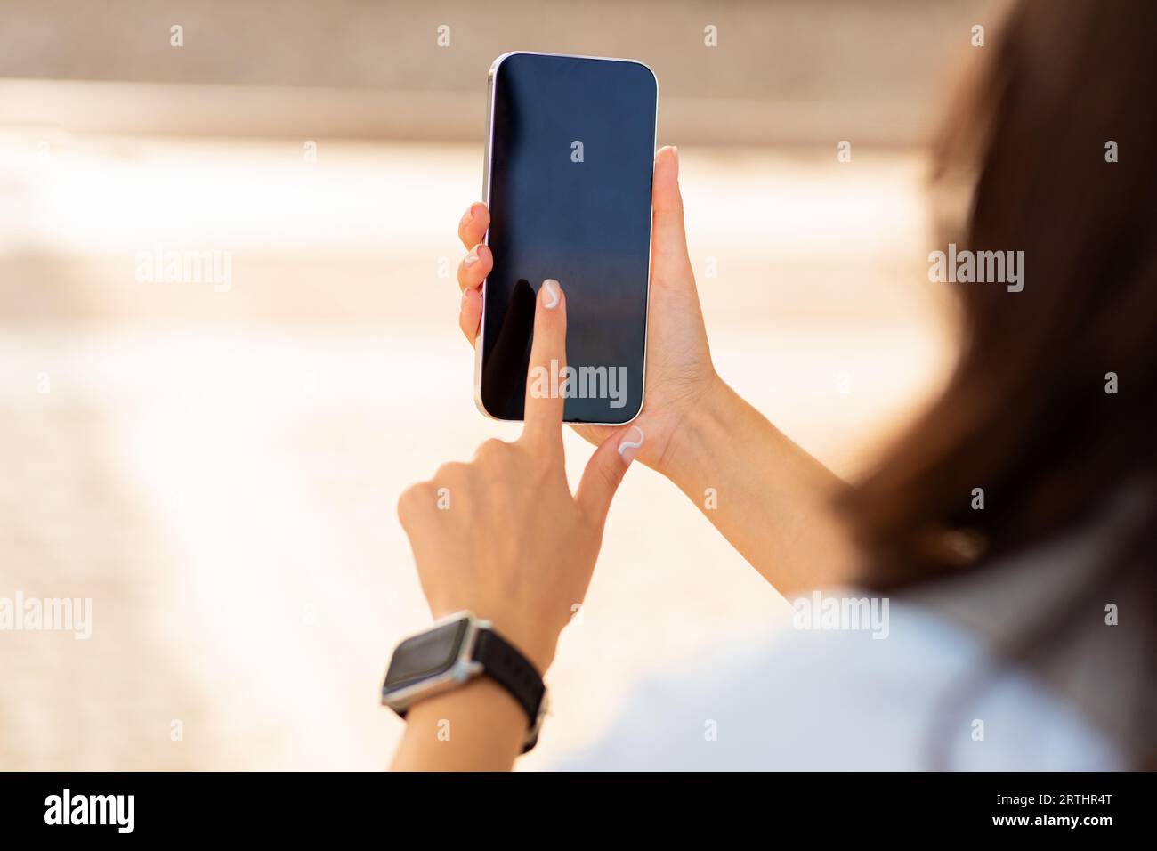 Young european lady use phone with blank screen, waiting for transport ...