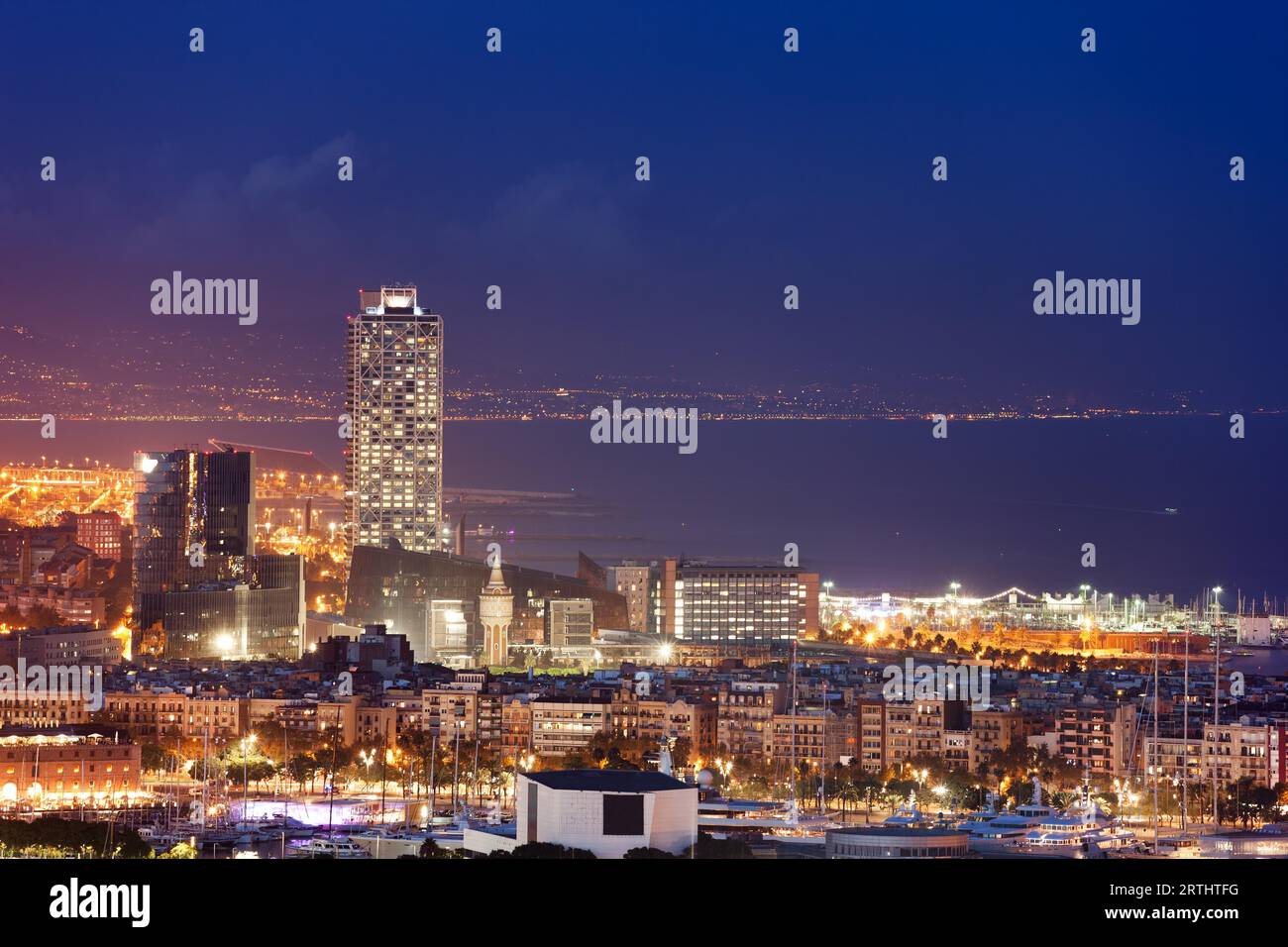 Spain, Barcelona city skyline at night by the Mediterranean Sea Stock ...