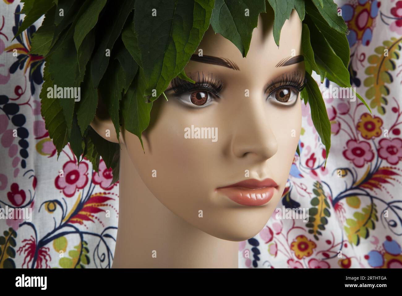 a display mannequin wearing hair of leaves and representing a nature ...