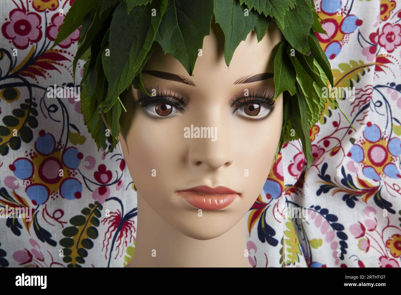 a display mannequin wearing hair of leaves and representing a nature ...