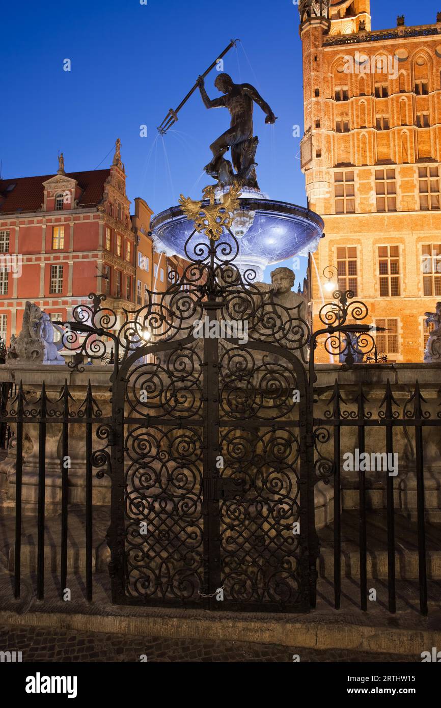 Neptune Fountain at night in city of Gdansk in Poland, bronze statue of ...