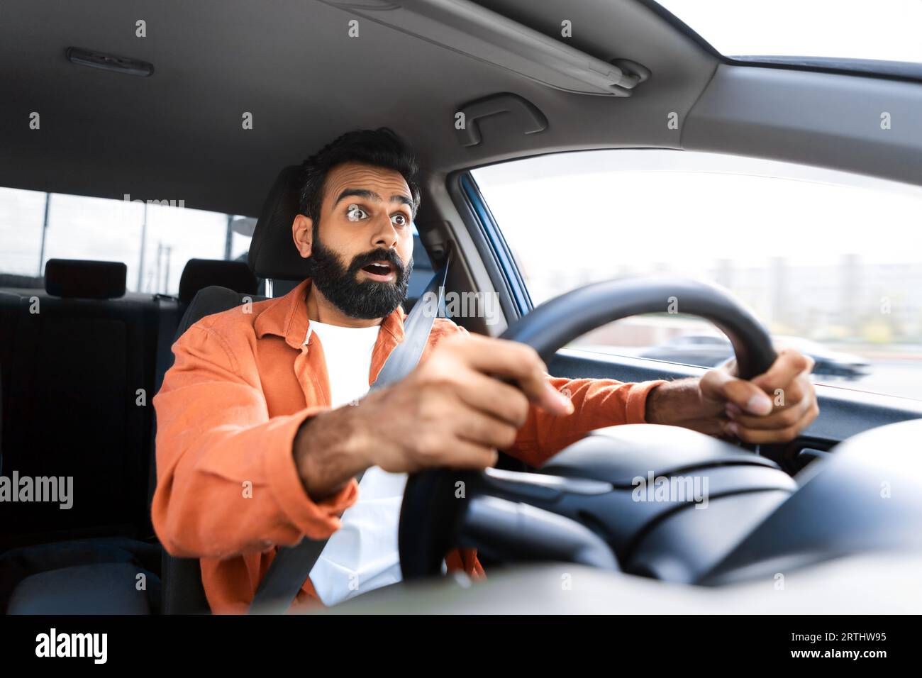 Scared indian man looking at road in shock driving auto Stock Photo - Alamy