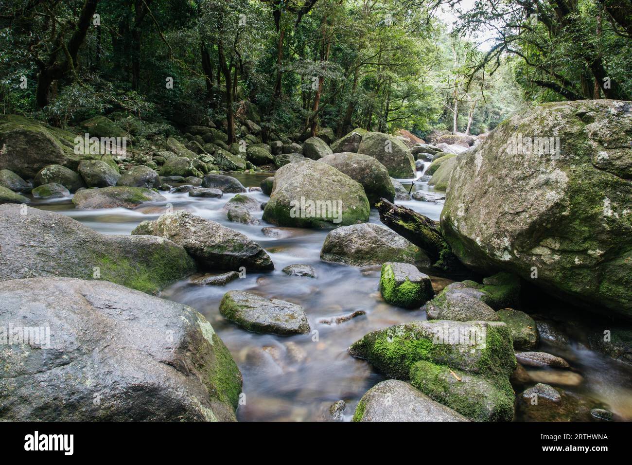 Water of the Mossman River flows over ancient rocks and boulders in ...