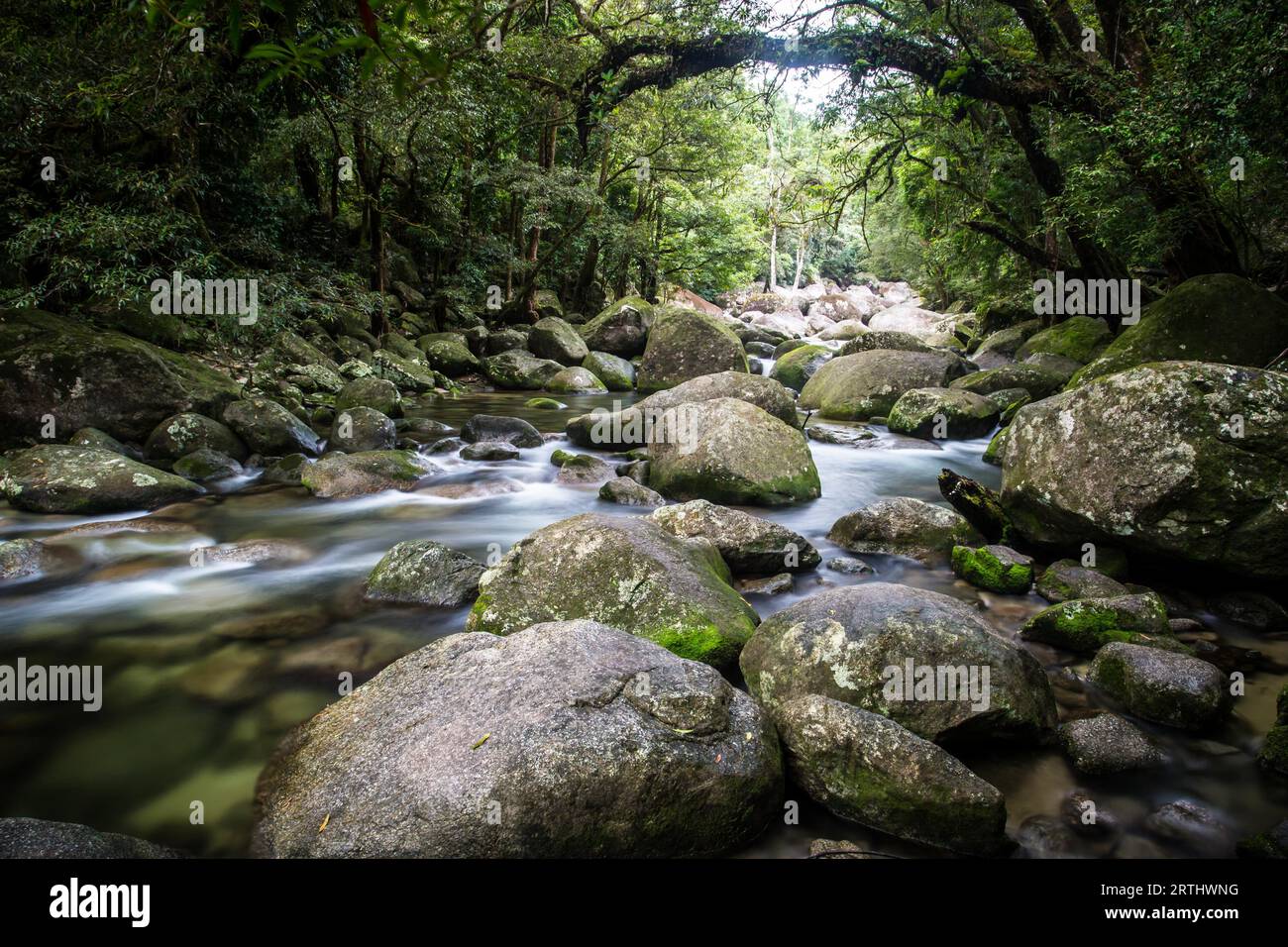 Water of the Mossman River flows over ancient rocks and boulders in ...