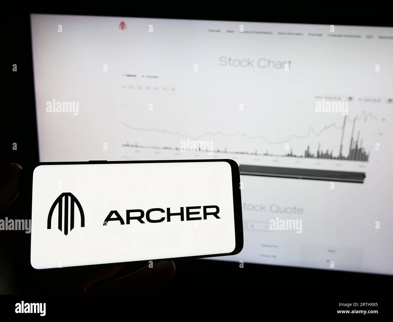 Person holding mobile phone with logo of US eVTOL aircraft company ...