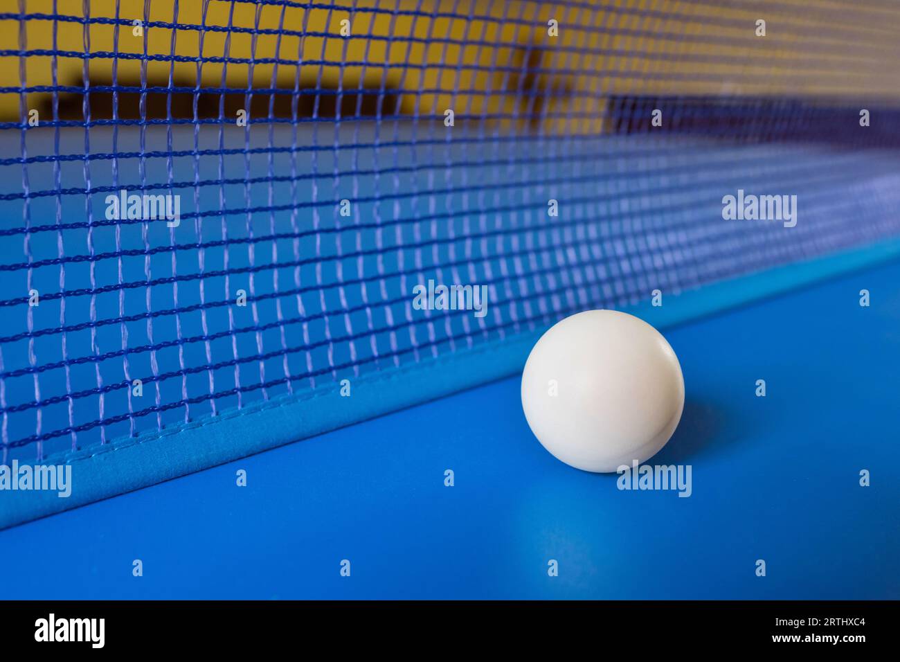 White table tennis ball on blue table with net. Table tennis Stock ...
