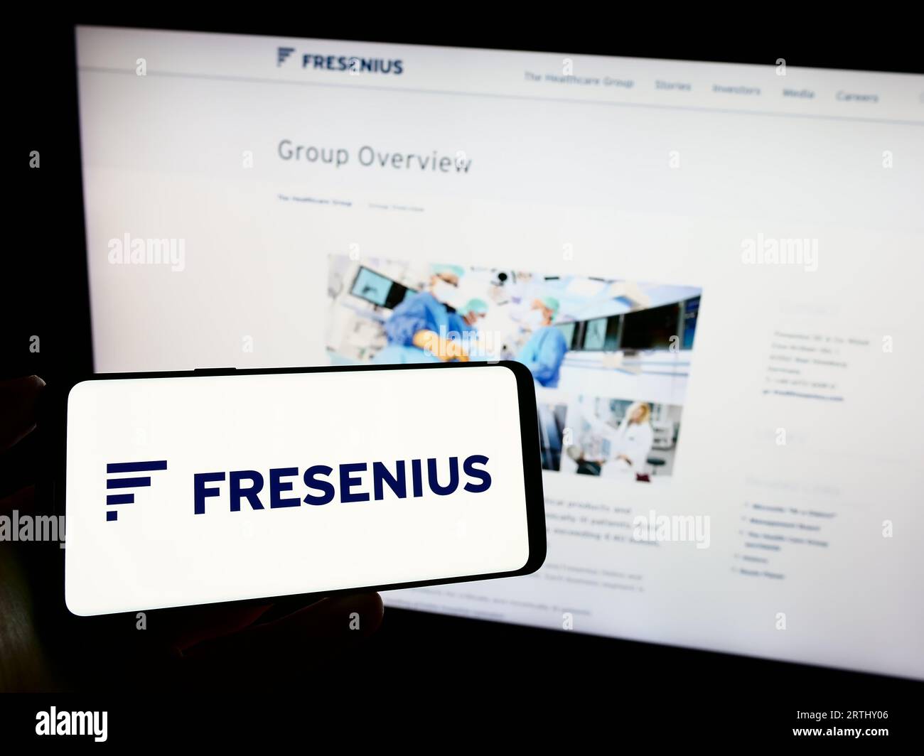 Person holding cellphone with logo of German healthcare company ...