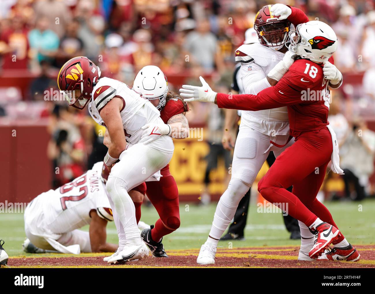 Washington Commanders QB Sam Howell (14) holding onto the ball as he is ...