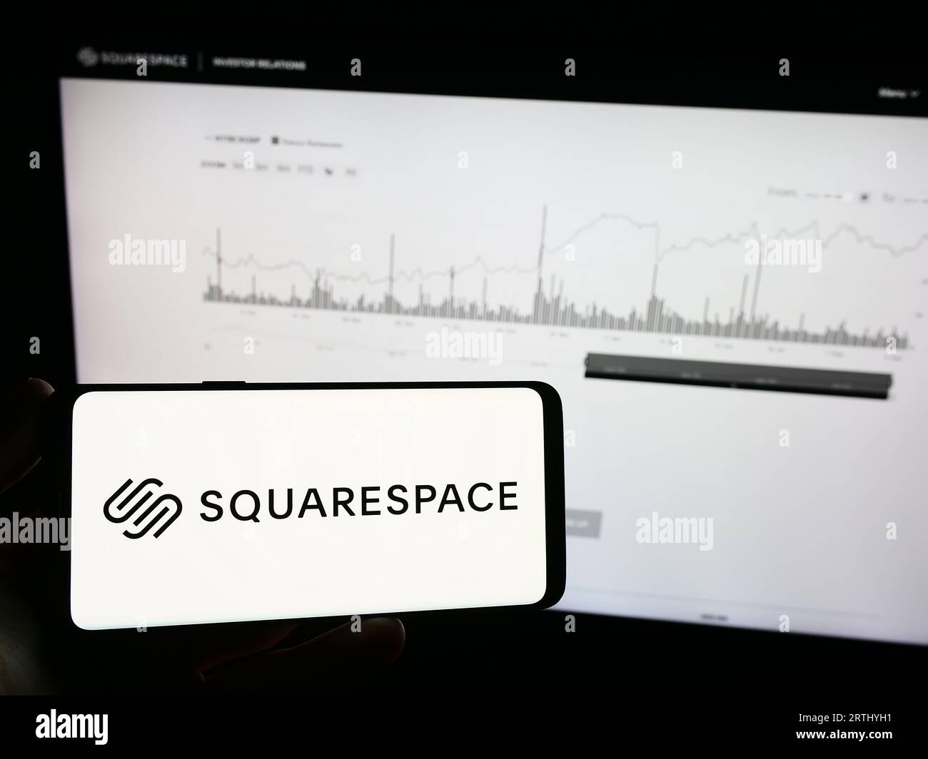 Person holding mobile phone with logo of US website building company Squarespace Inc. on screen ...