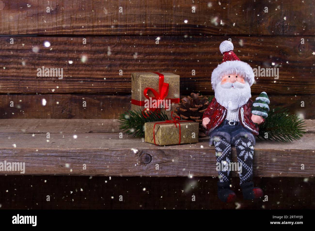 Christmas golden gift box, santa claus toy and fallen snow Stock Photo ...