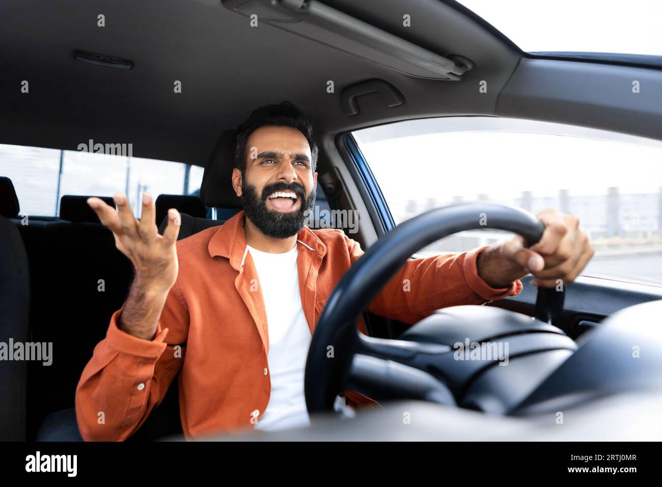 Mad indian man shouting while sitting in auto driver seat Stock Photo ...