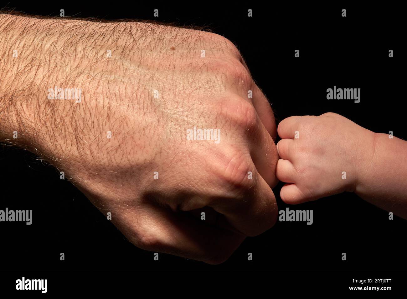 Baby strong touching dad Stock Photo - Alamy