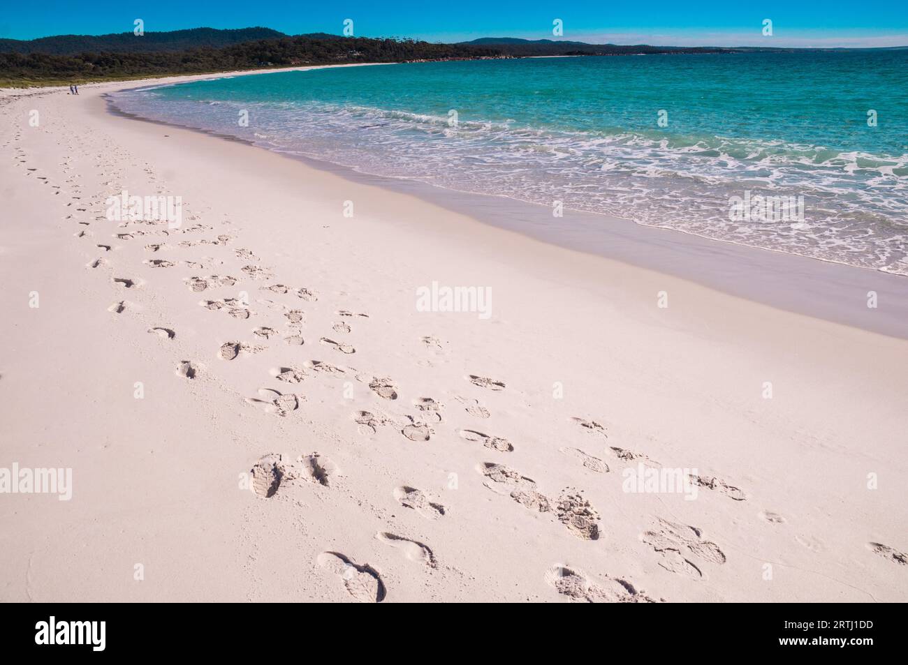 A track of footsteps leads along Binalong Bay beach at Bay of Fires ...