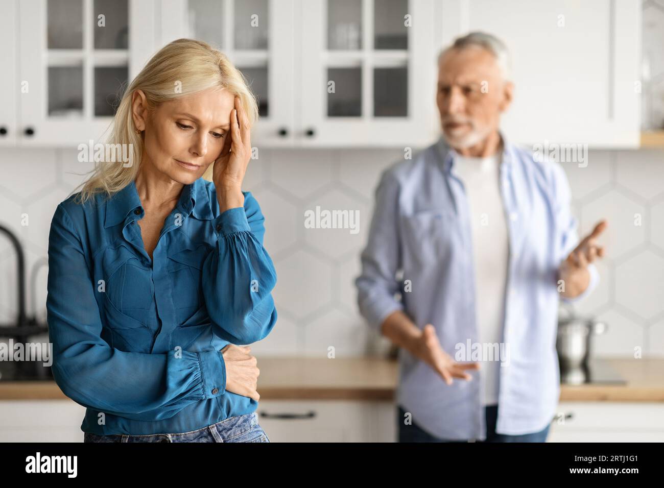Portrait Of Upset Elderly Couple Arguing Together In Kitchen Interior ...